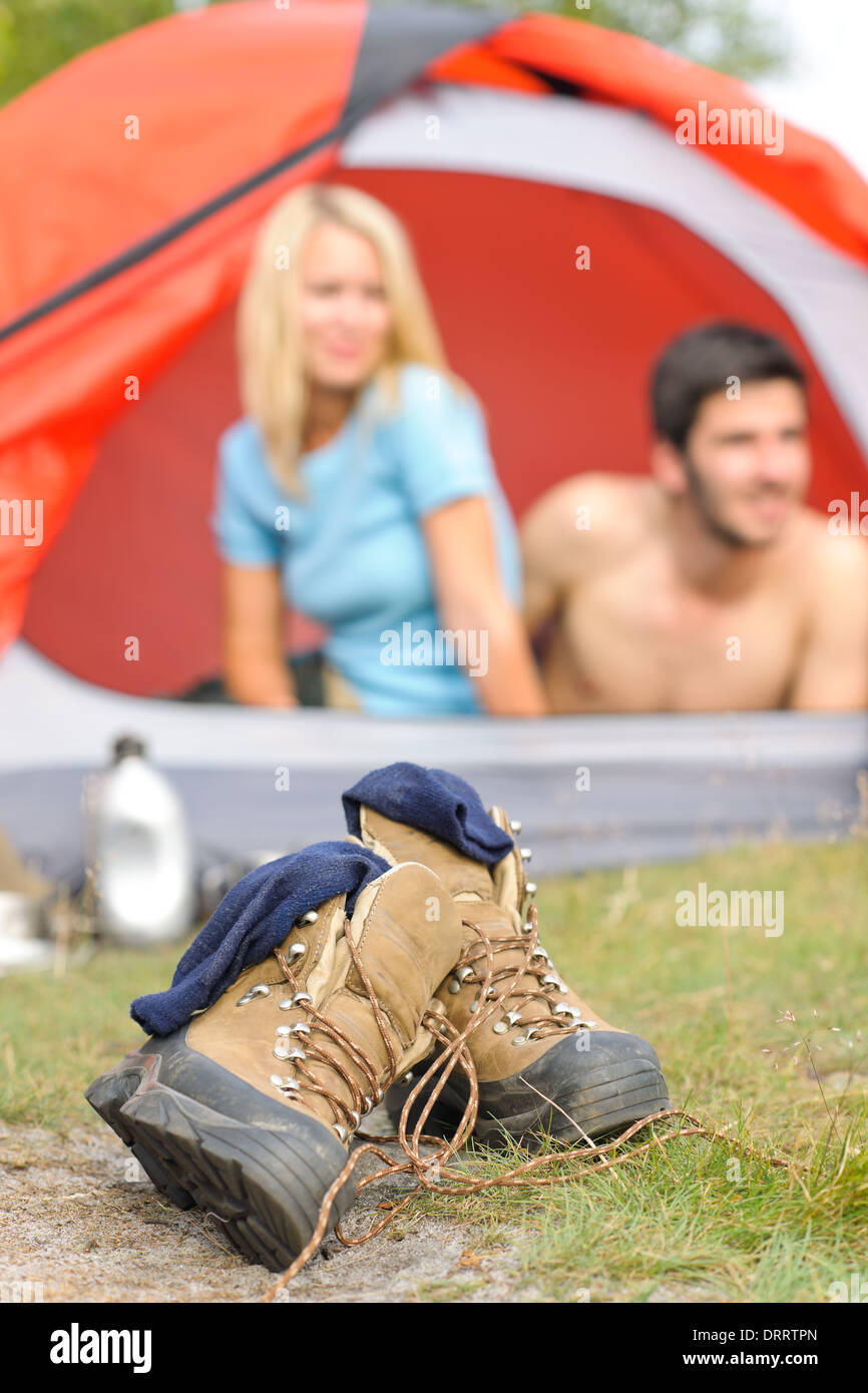 Hiking boots outside tent camping couple Stock Photo - Alamy