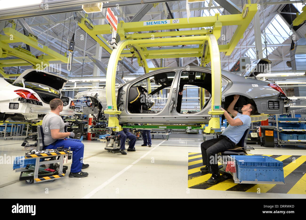 Employees work on Mercedes cars during the production of S-Class ...
