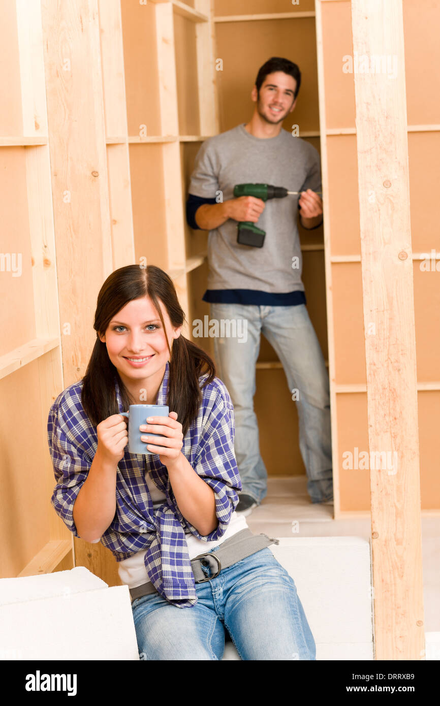 Home improvement young couple fixing wall Stock Photo - Alamy