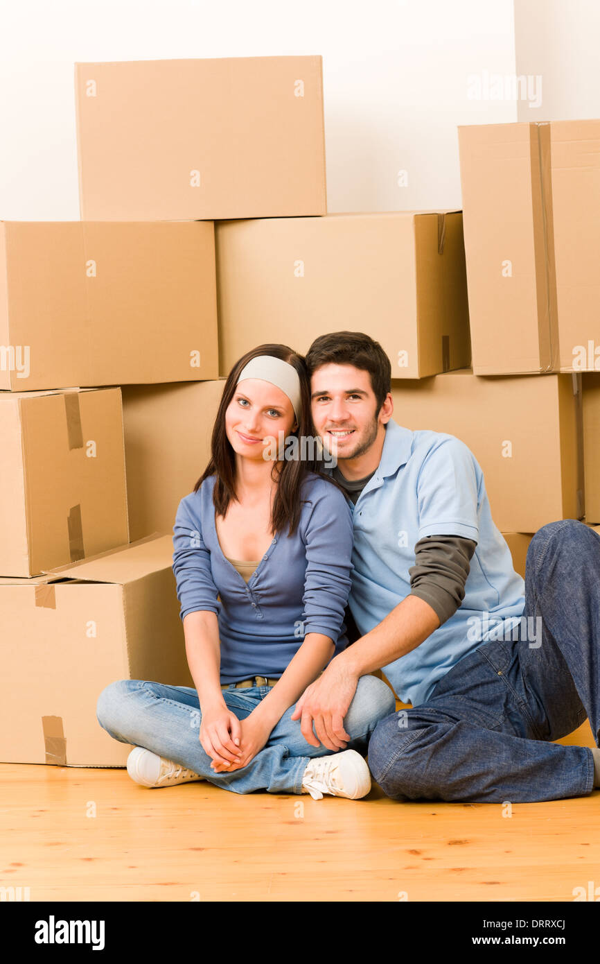 Moving new home young couple sitting floor Stock Photo - Alamy