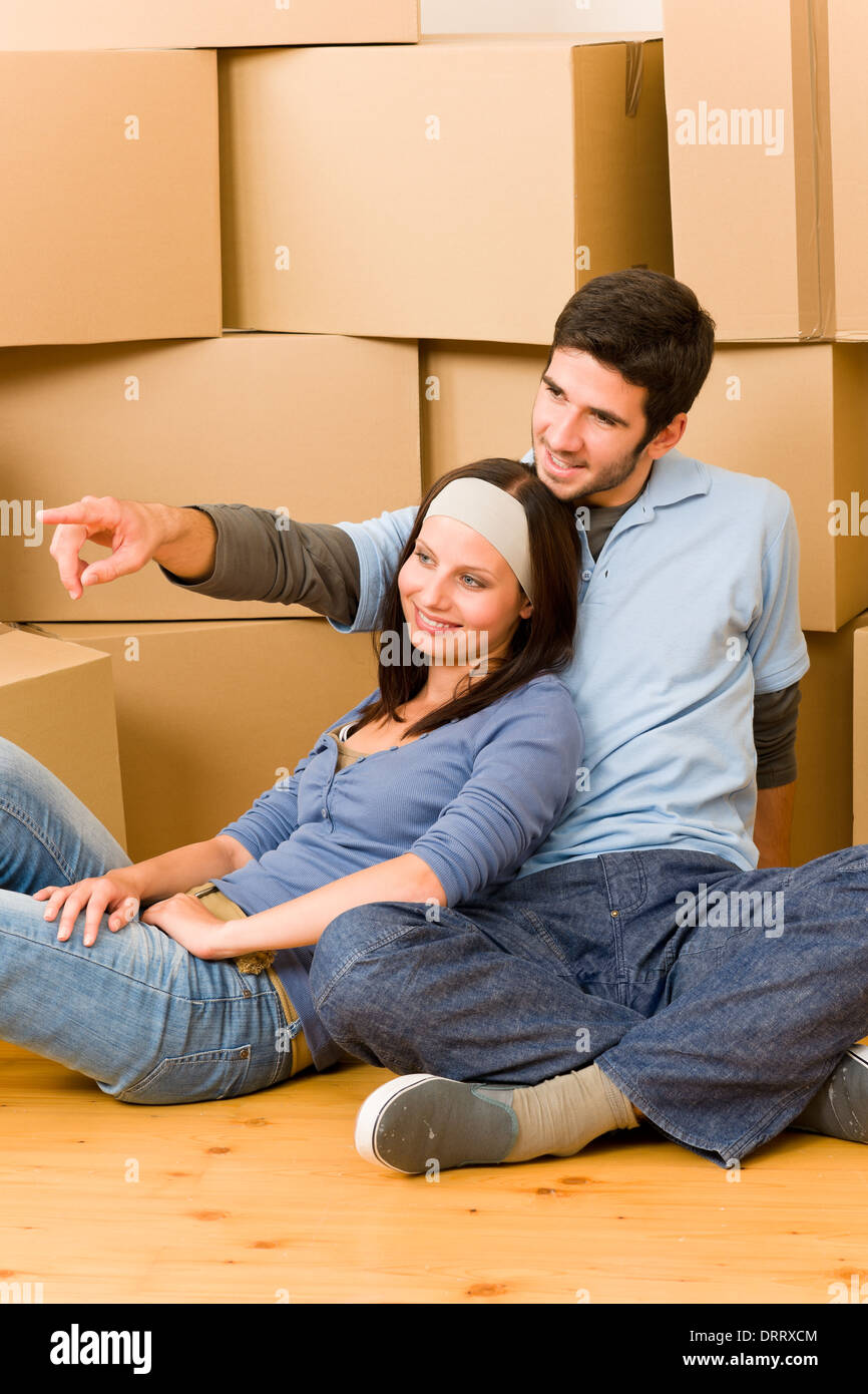 Moving new home young couple sitting floor Stock Photo - Alamy