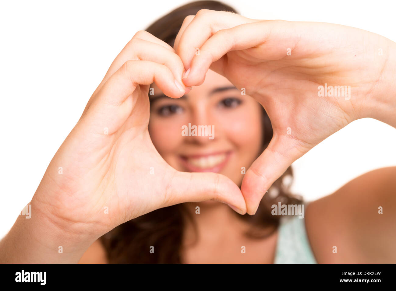 Beautiful woman making a heart shape with her hands, isolated over ...