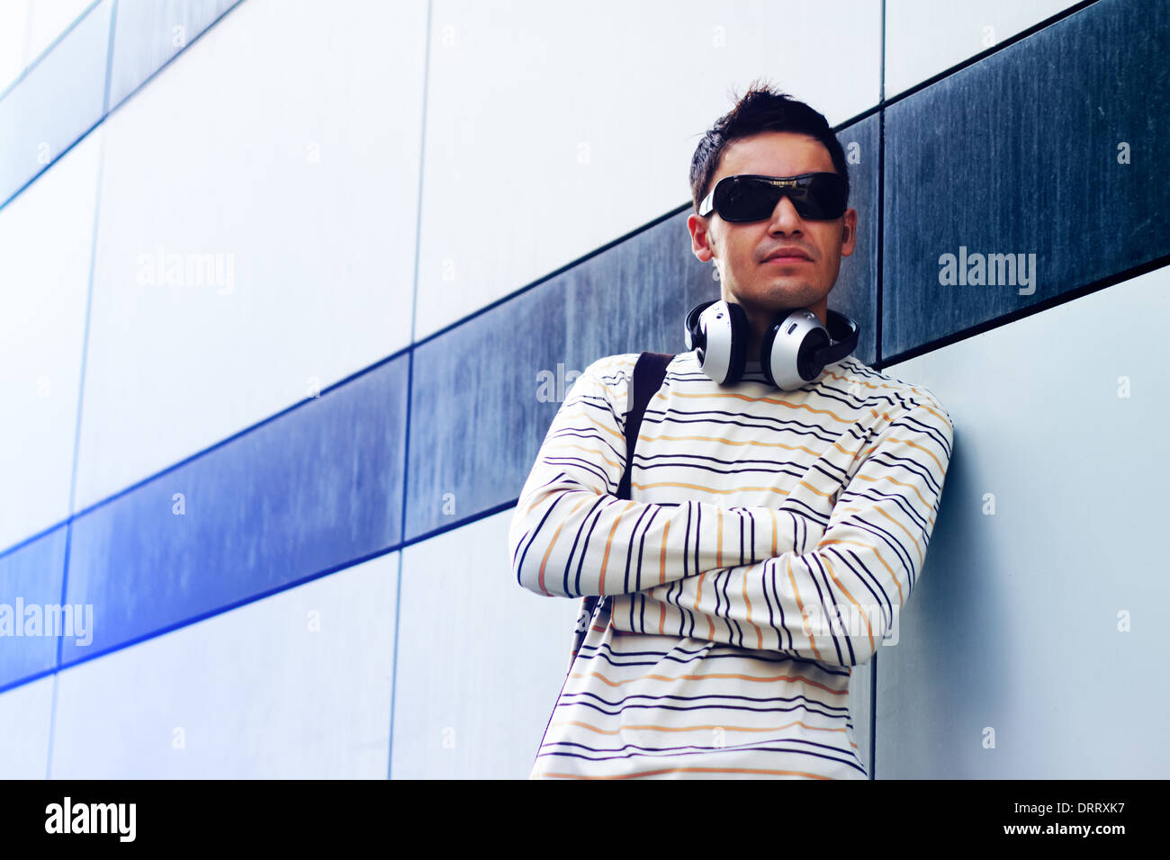 A man stands near a wall Stock Photo - Alamy