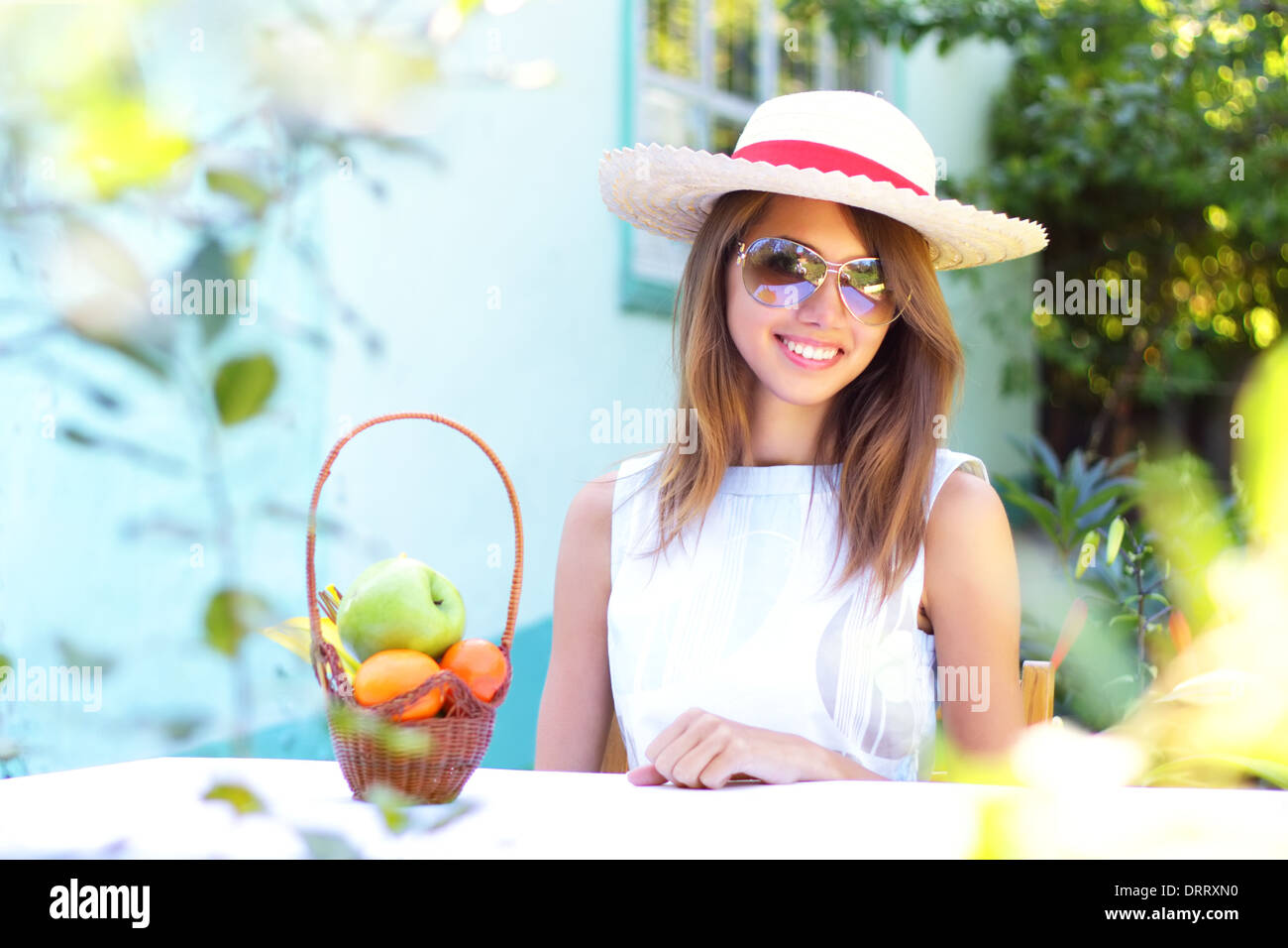 A beautiful girl sitting at the table Stock Photo - Alamy
