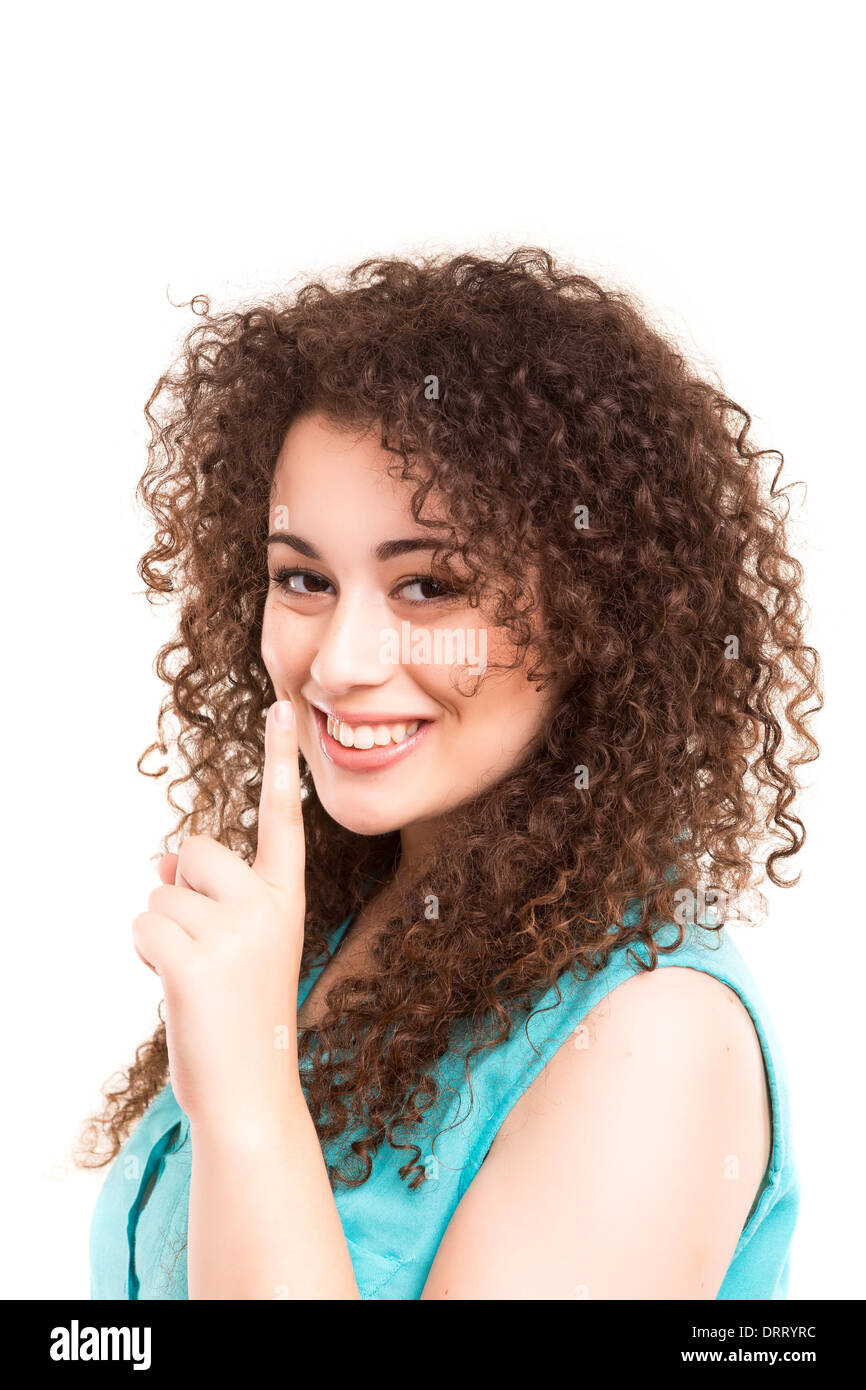 A beautiful woman pointing to something, isolated over a white ...