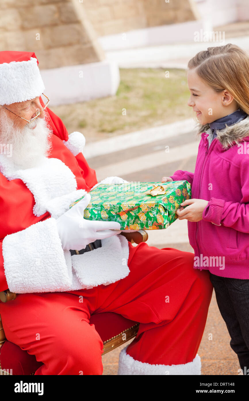 Girl Receiving Present From Santa Claus Stock Photo - Alamy
