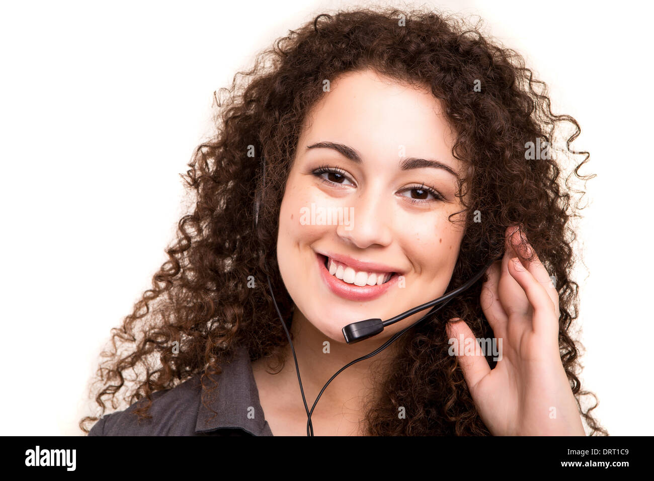 A friendly asian telephone operator smiling isolated over a white ...
