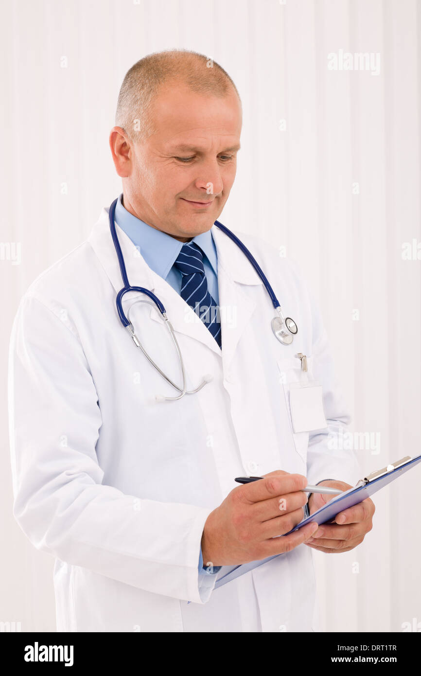 Mature doctor male portrait write document Stock Photo - Alamy