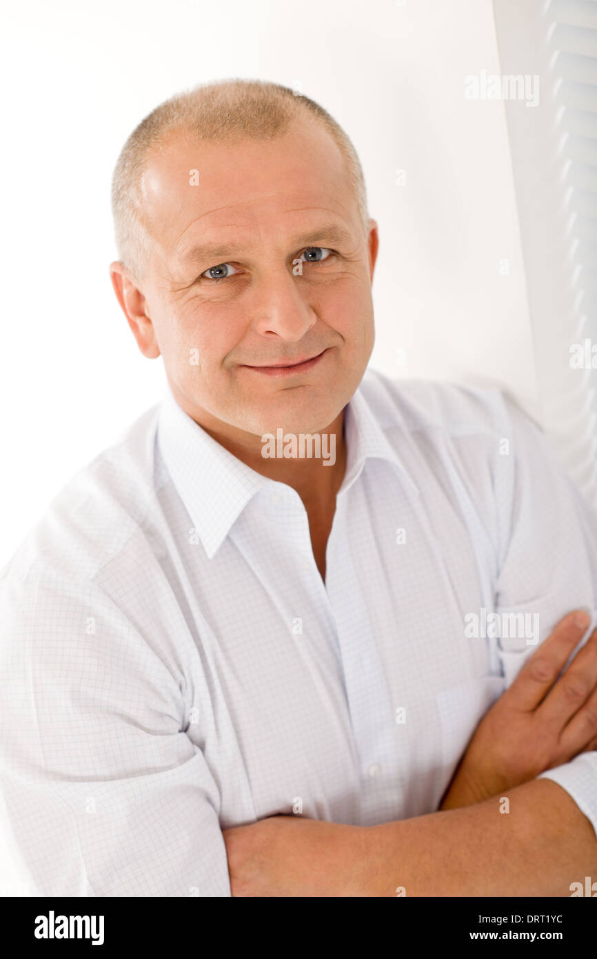 Mature businessman smile cross arms posing Stock Photo - Alamy