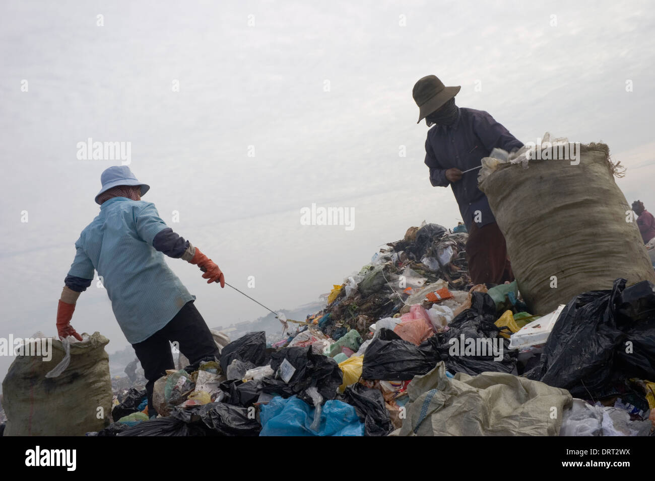 Wet plastic and rotting garbage provides the work environment at the ...