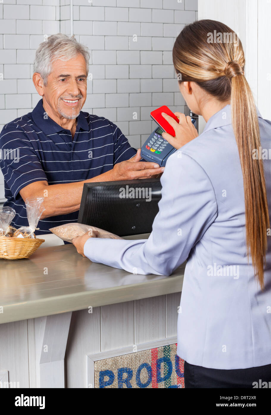 Customer paying cash in shop hi-res stock photography and images - Alamy