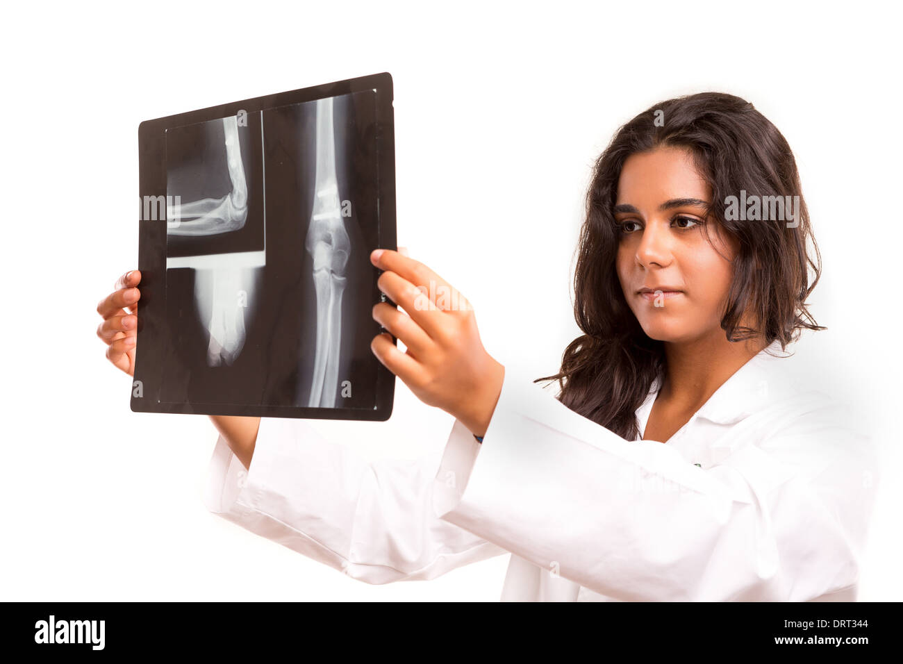 Beautiful young doctor looking at a X-Ray, isolated over white Stock ...