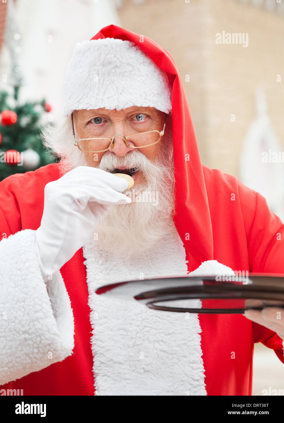 Santa Claus Eating Cookies Outdoors Stock Photo - Alamy
