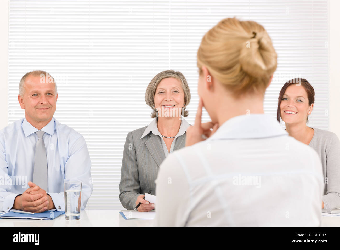 Job interview young woman with business team Stock Photo - Alamy