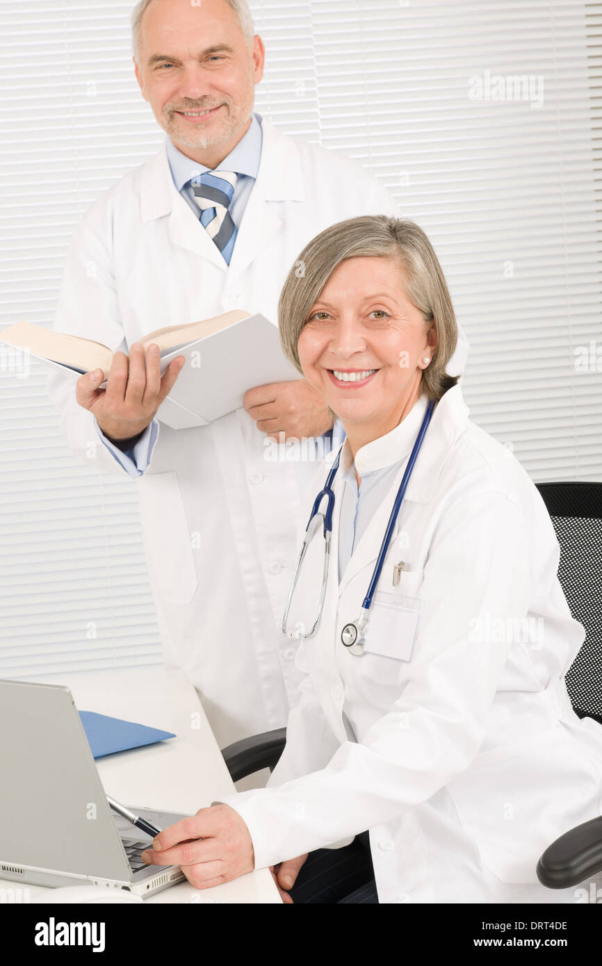 Medical team doctors by desk work computer Stock Photo - Alamy