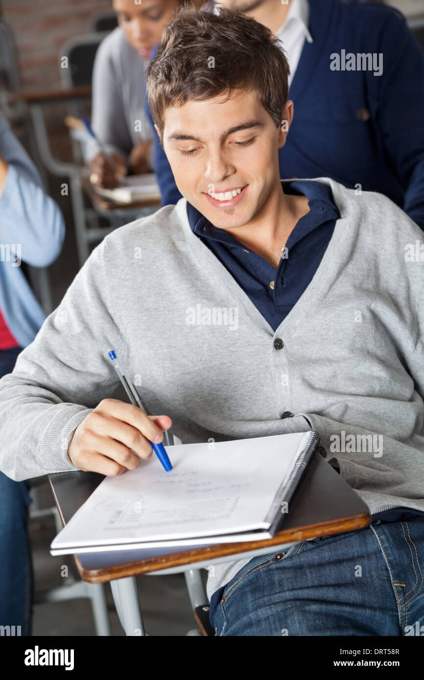 Student Looking At Exam Paper In Classroom Stock Photo - Alamy