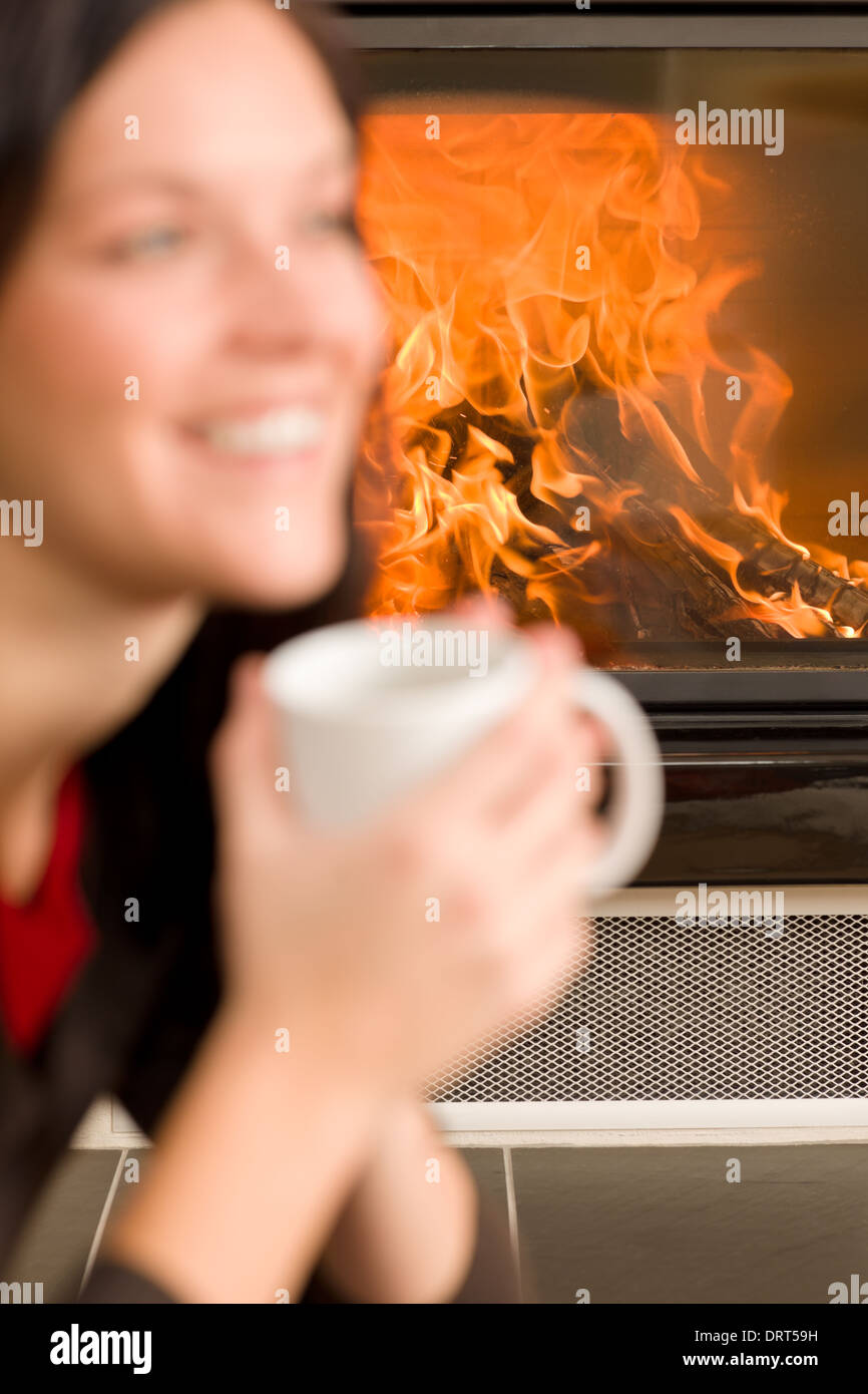 Woman by fireplace home drink Stock Photo - Alamy