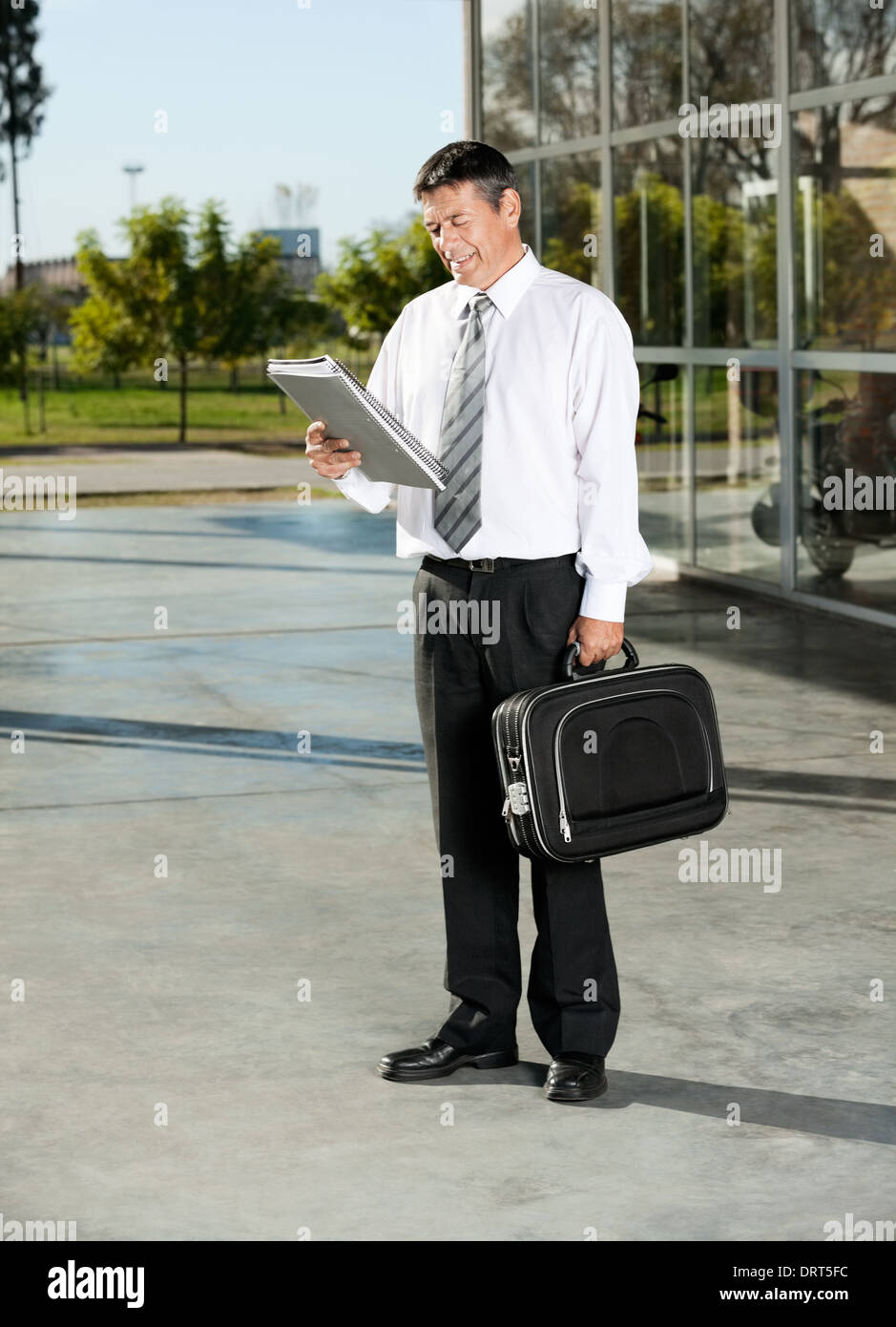 Male Professor Reading Book At University Campus Stock Photo - Alamy