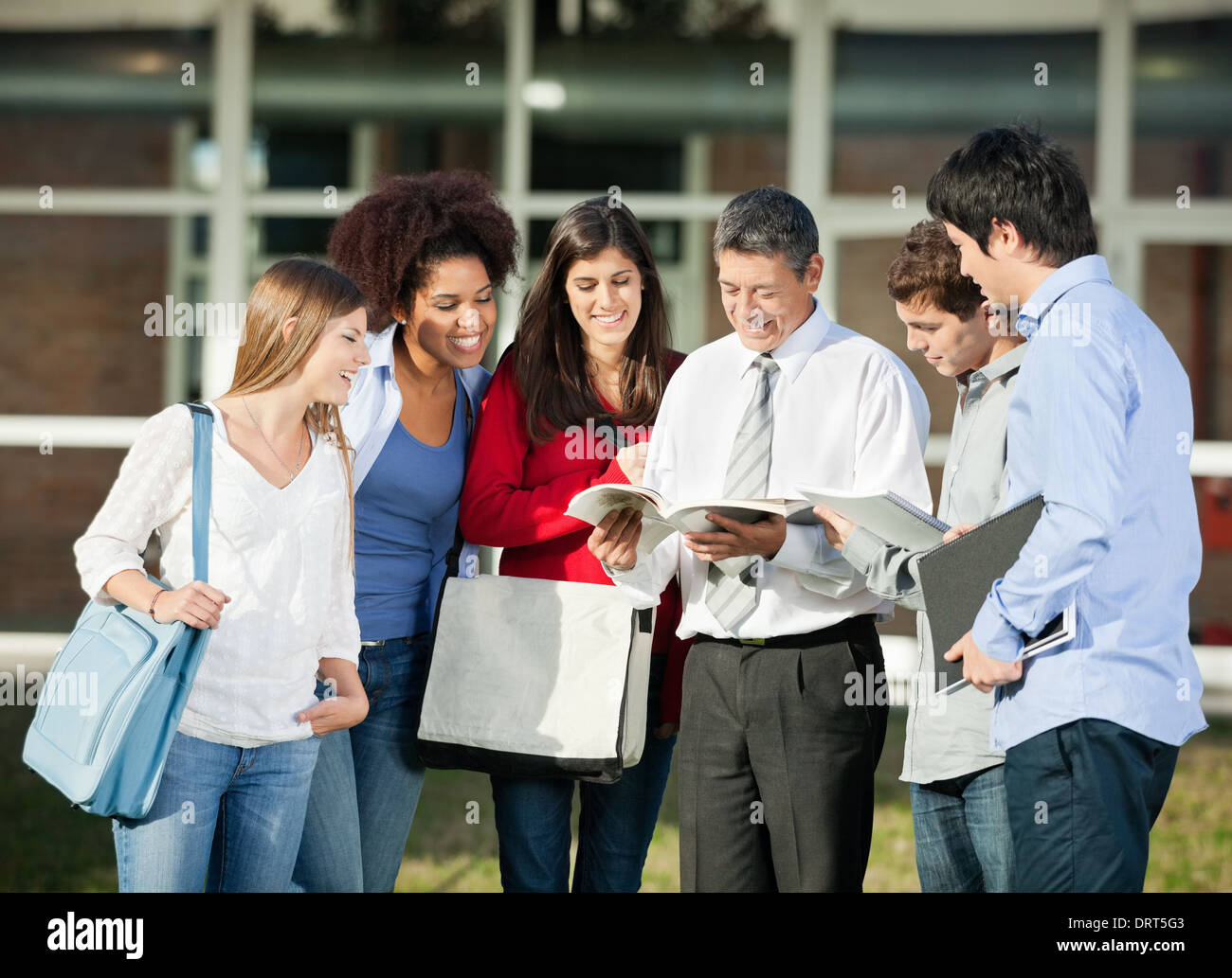 Teacher Explaining Lesson To Students On College Campus Stock Photo - Alamy