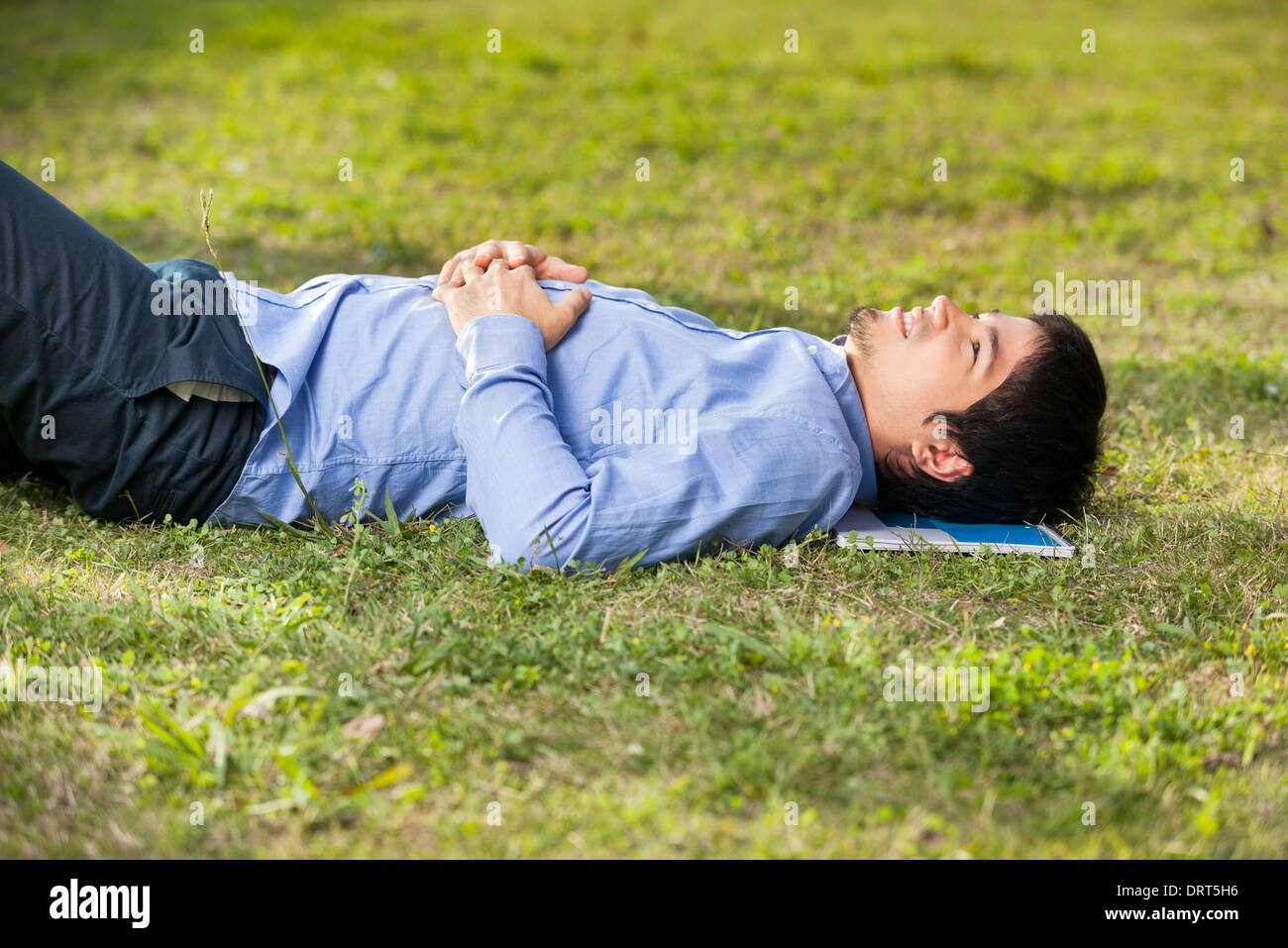 Student Relaxing On Grass At University Campus Stock Photo - Alamy