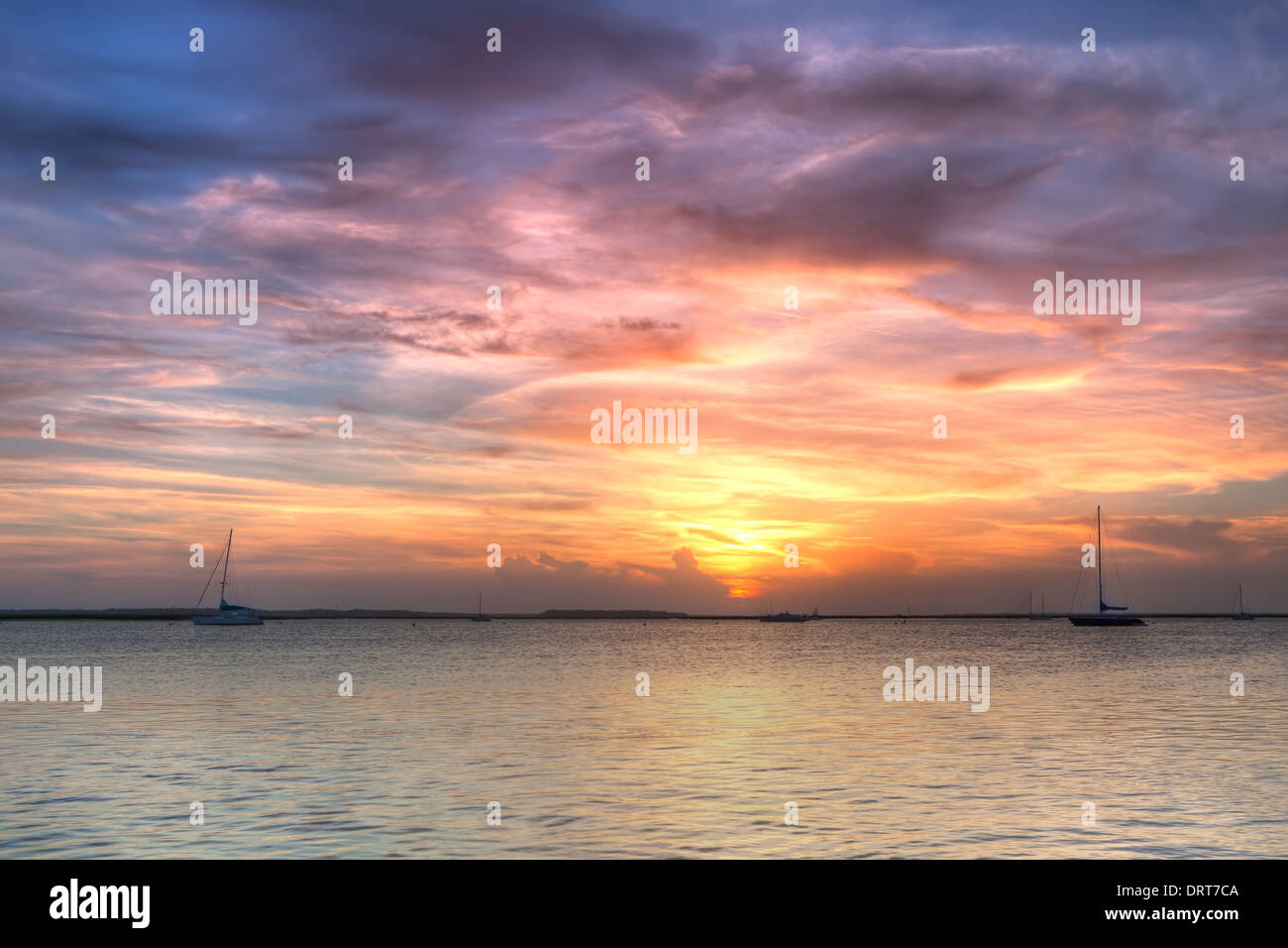 Yachts in the ocean at sunset Stock Photo - Alamy