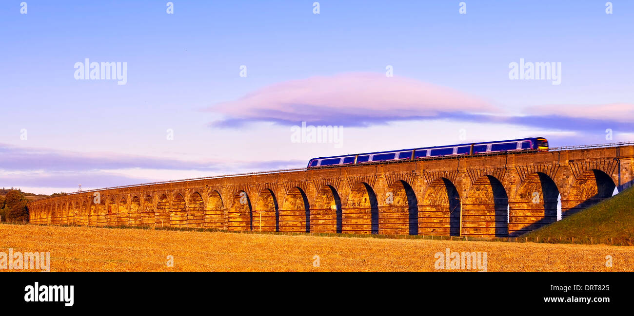 Old masonry arched viaduct carrying a train near Edinburgh, Scotland ...