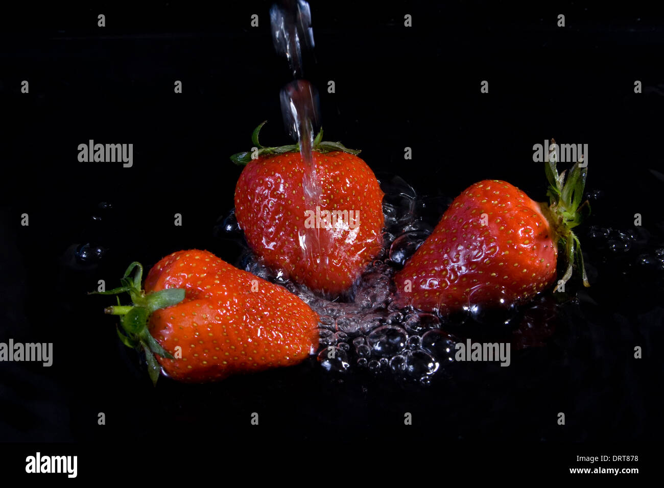 Strawberries in flowing water Stock Photo - Alamy