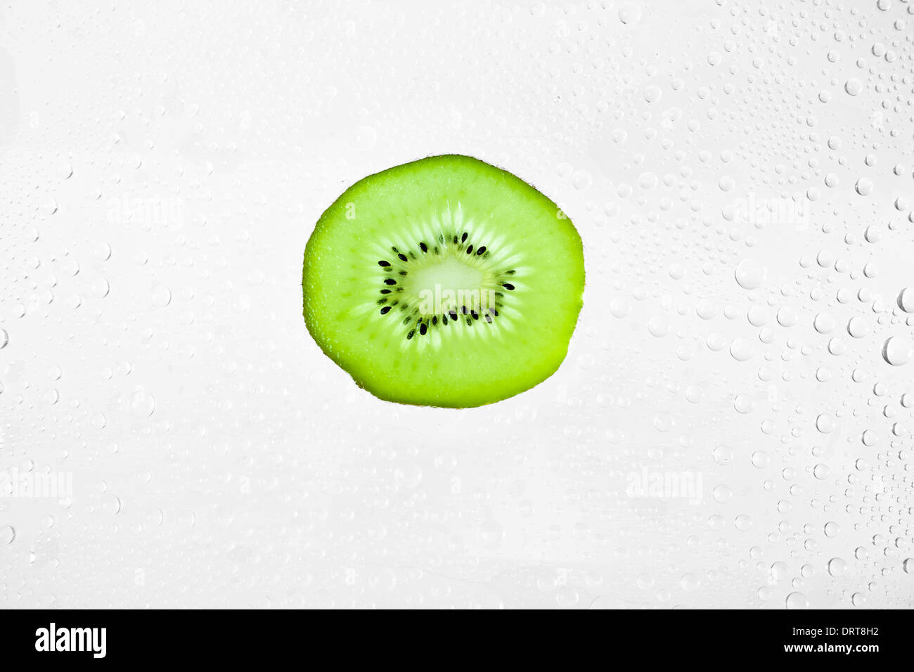 Kiwi segment on white abstract background Stock Photo - Alamy