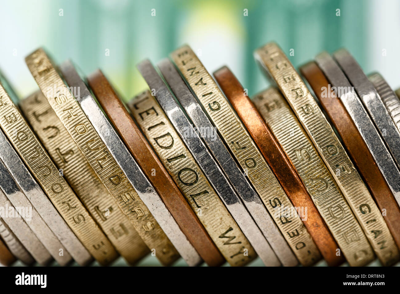 Various coins shown against banknote background Stock Photo - Alamy
