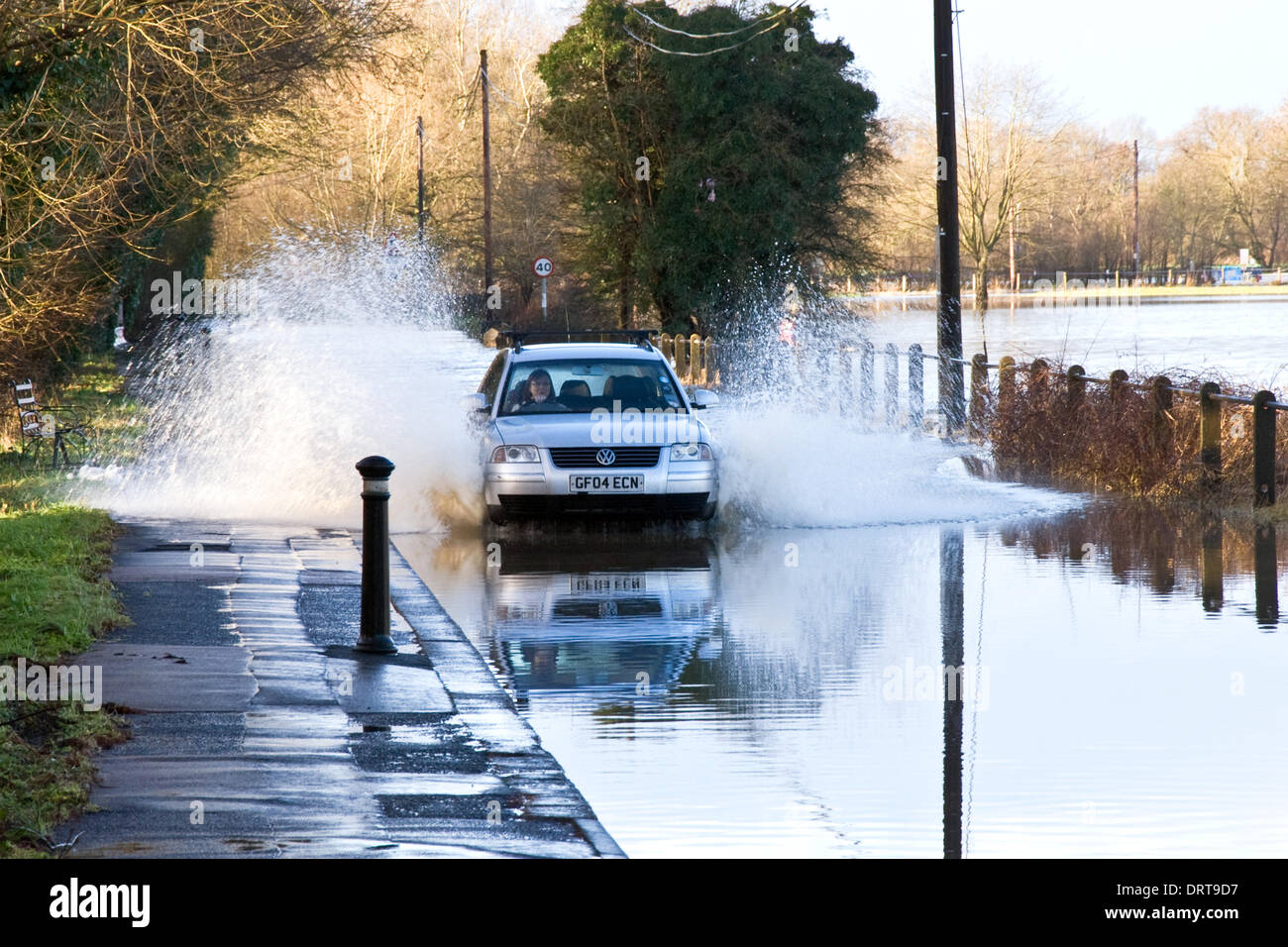 A motorist drives through flood water Stock Photo - Alamy