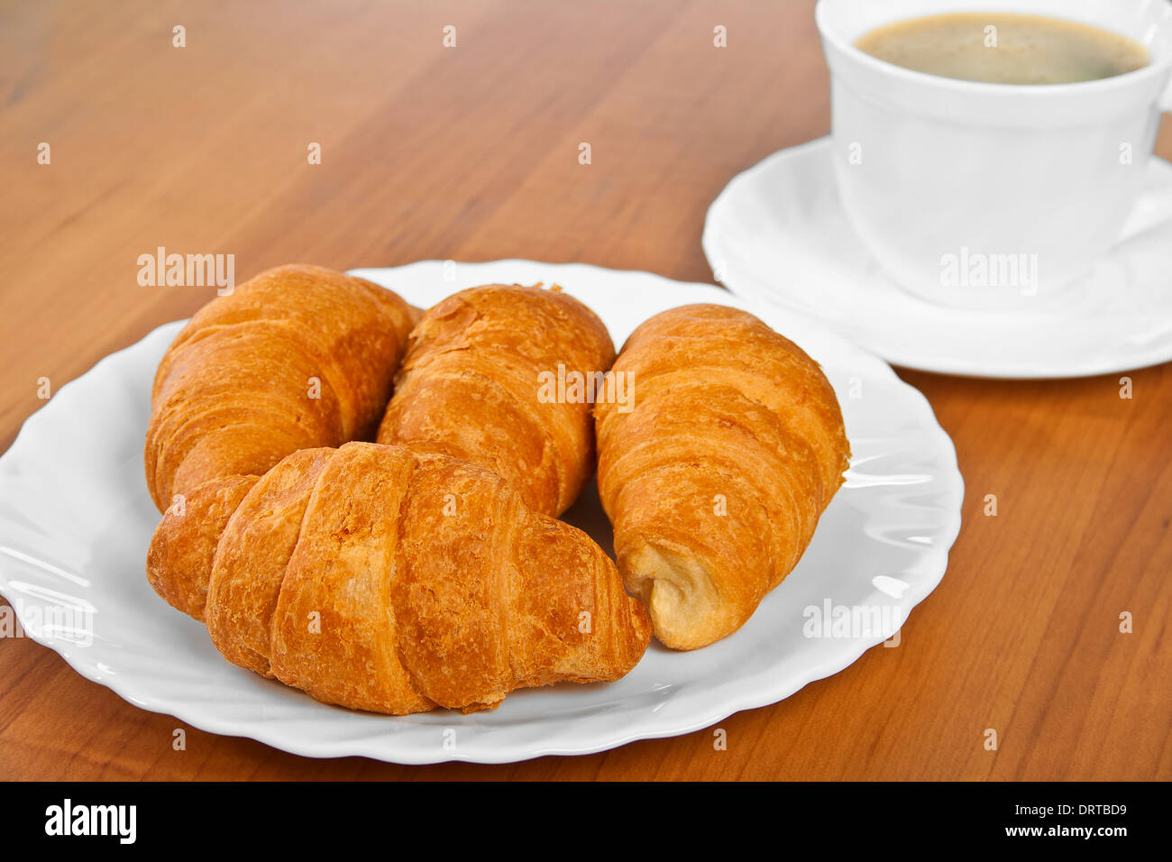 Newly-baked croissants and cup of coffee Stock Photo - Alamy