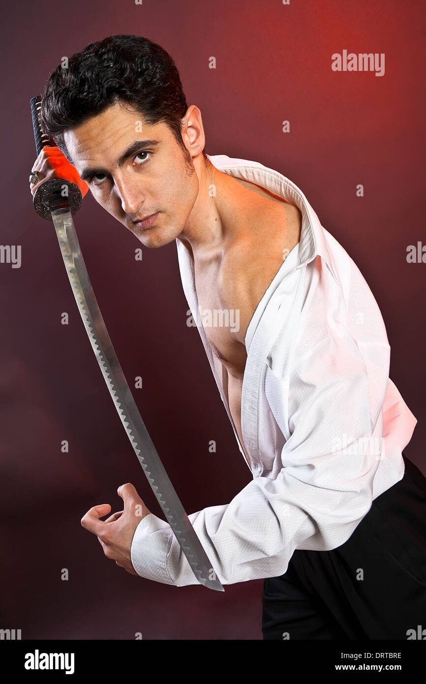 Handsome man with sword Stock Photo - Alamy