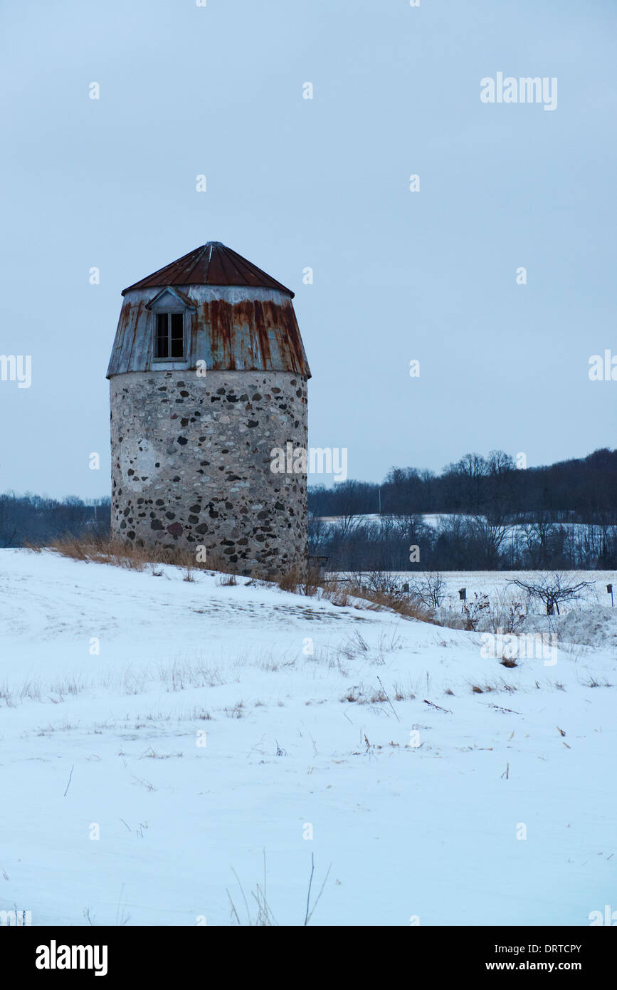 Old stone silo in the countryside in winter surrounded by snow Stock ...