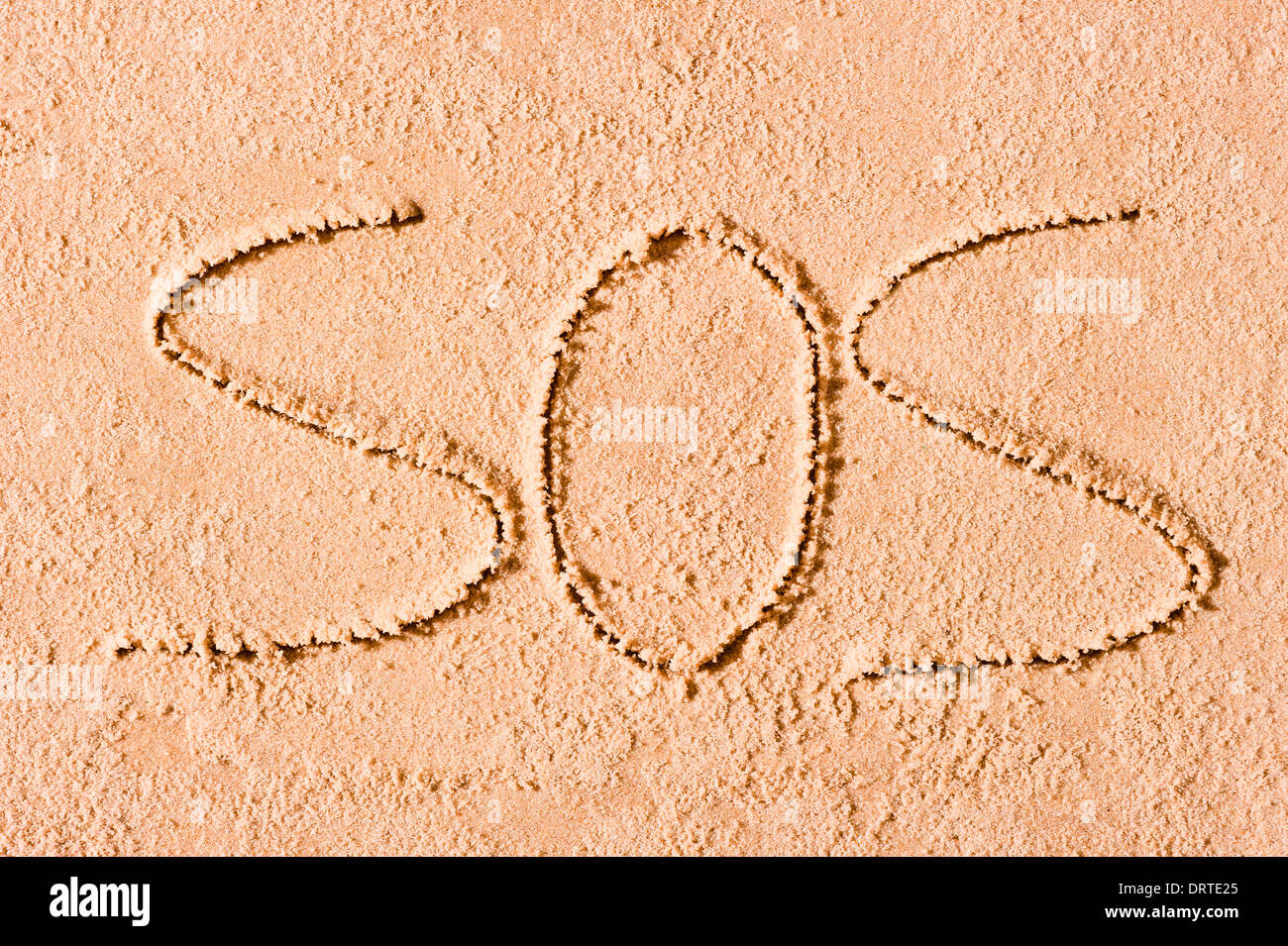 SOS written in the sand on the beach in large letters Stock Photo - Alamy