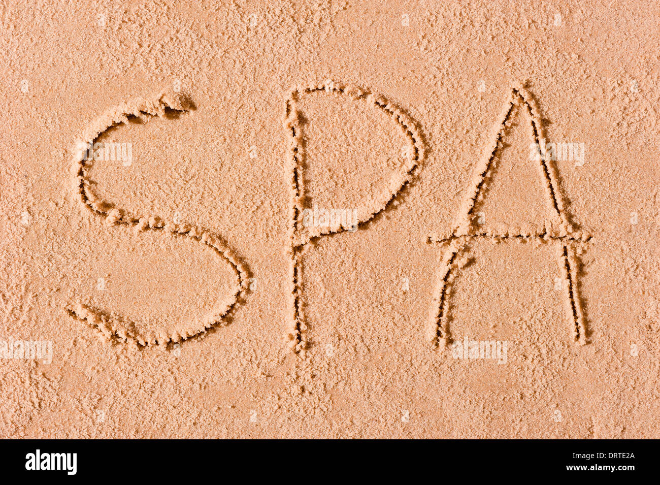 Spa is written in the sand on the beach in large letters Stock Photo ...
