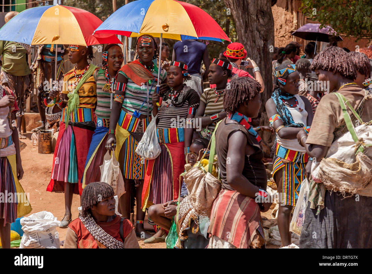 Young Banna Women Stand Under Umbrellas At The Thursday Market In Key ...