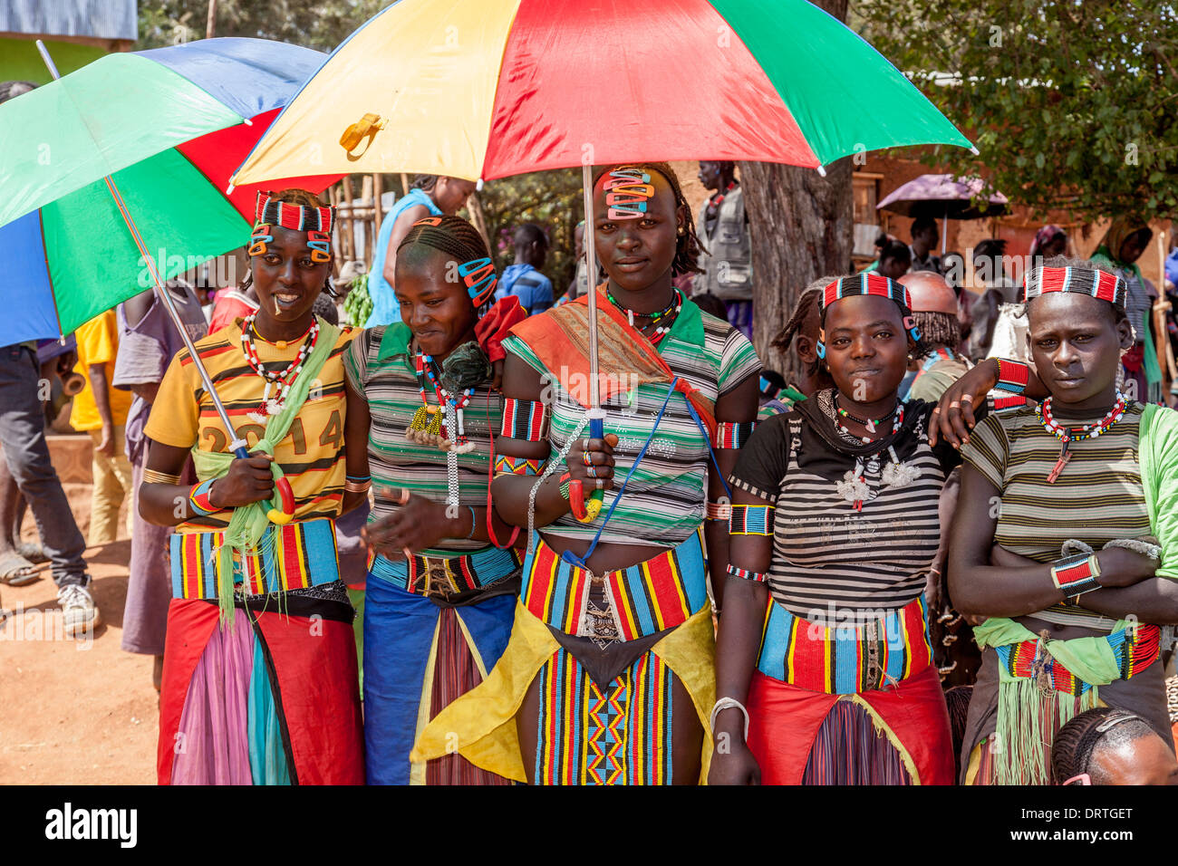 Young Banna Women Stand Under Umbrellas At The Thursday Market In Key ...