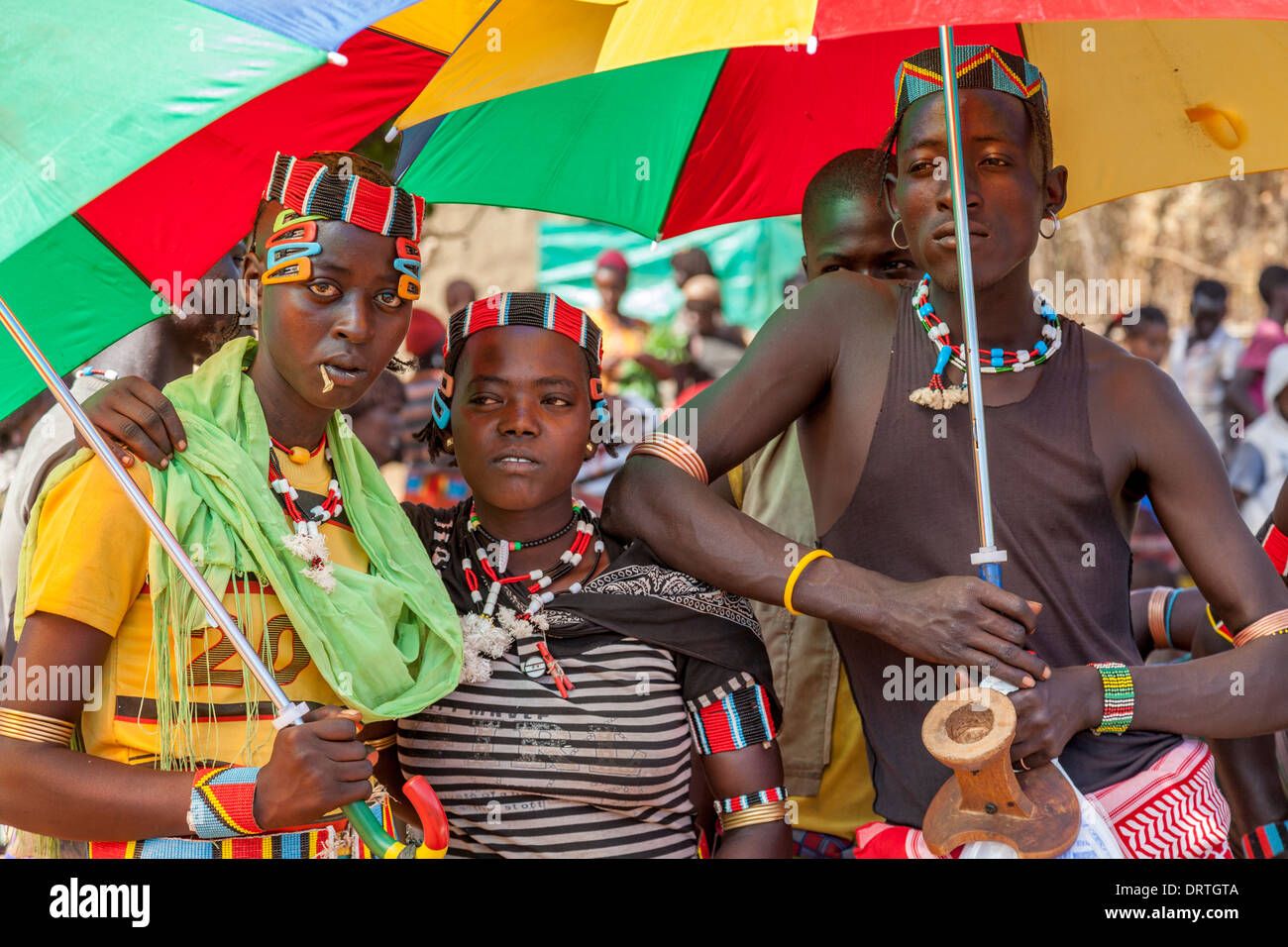 Young People From The Banna Tribe Stand Under Umbrellas At The Thursday ...