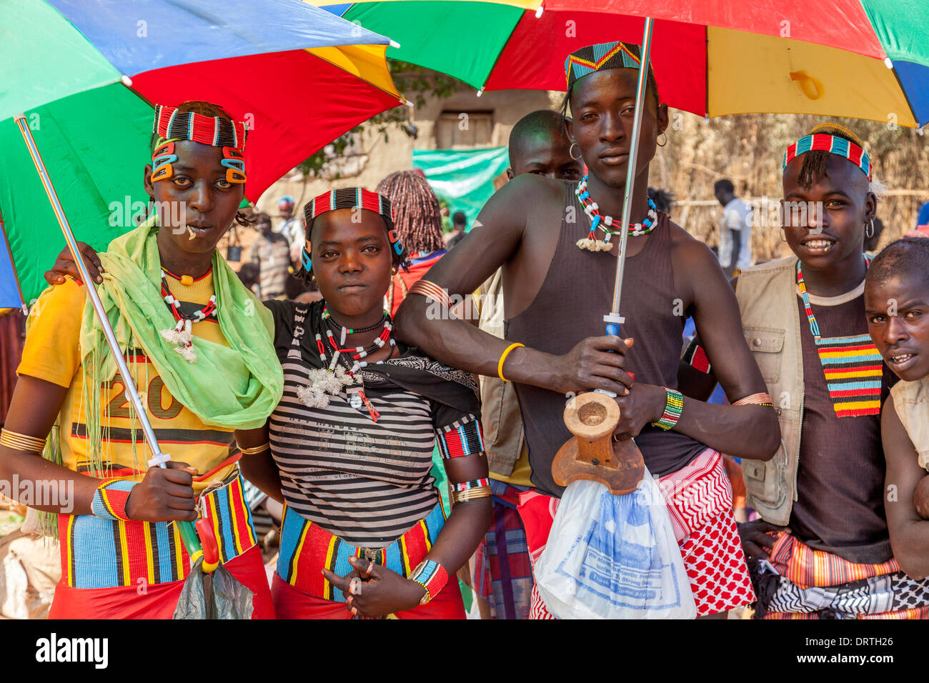 Young People From The Banna Tribe Stand Under Umbrellas At The Thursday ...