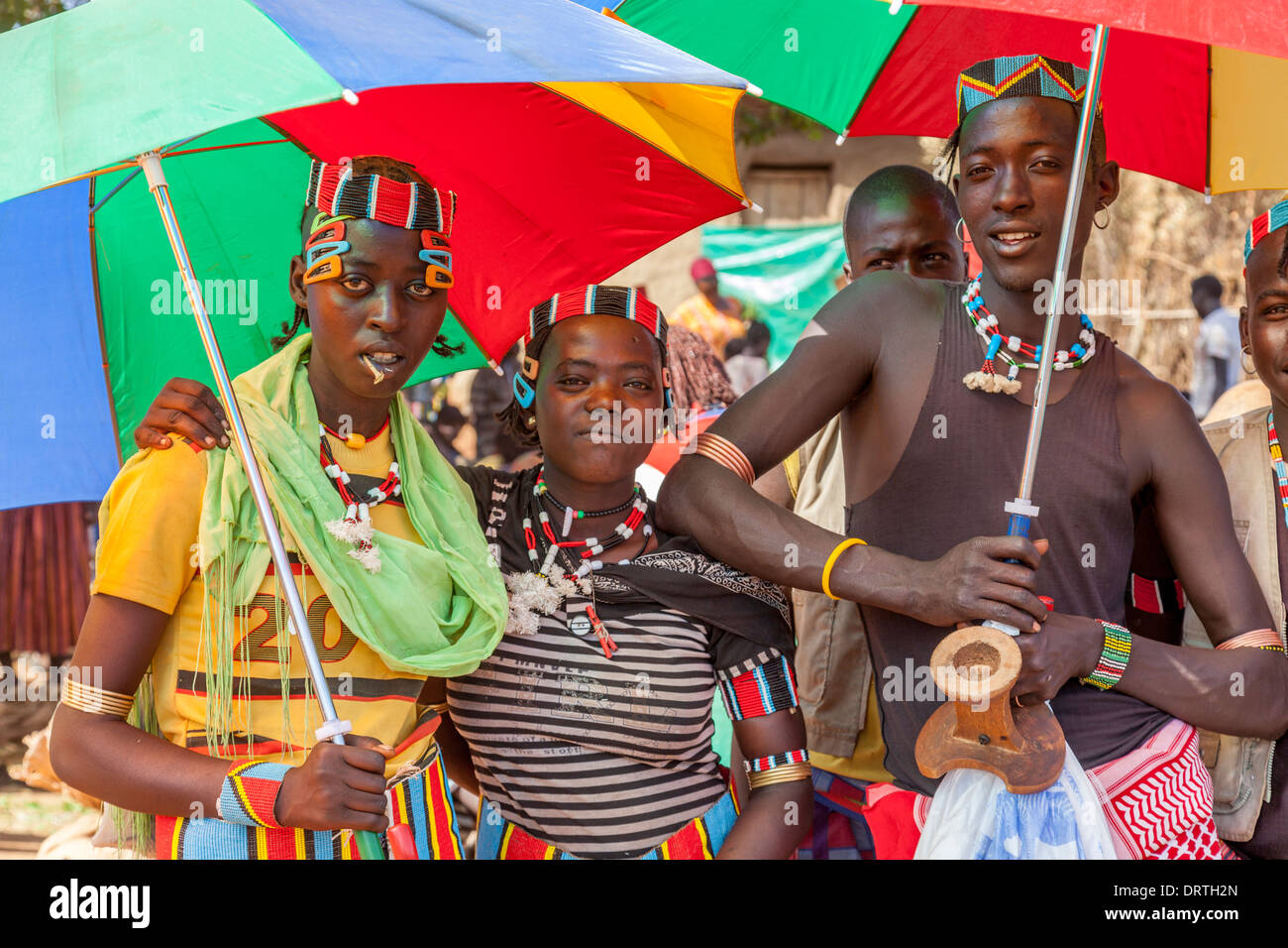 Young People From The Banna Tribe Stand Under Umbrellas At The Thursday ...