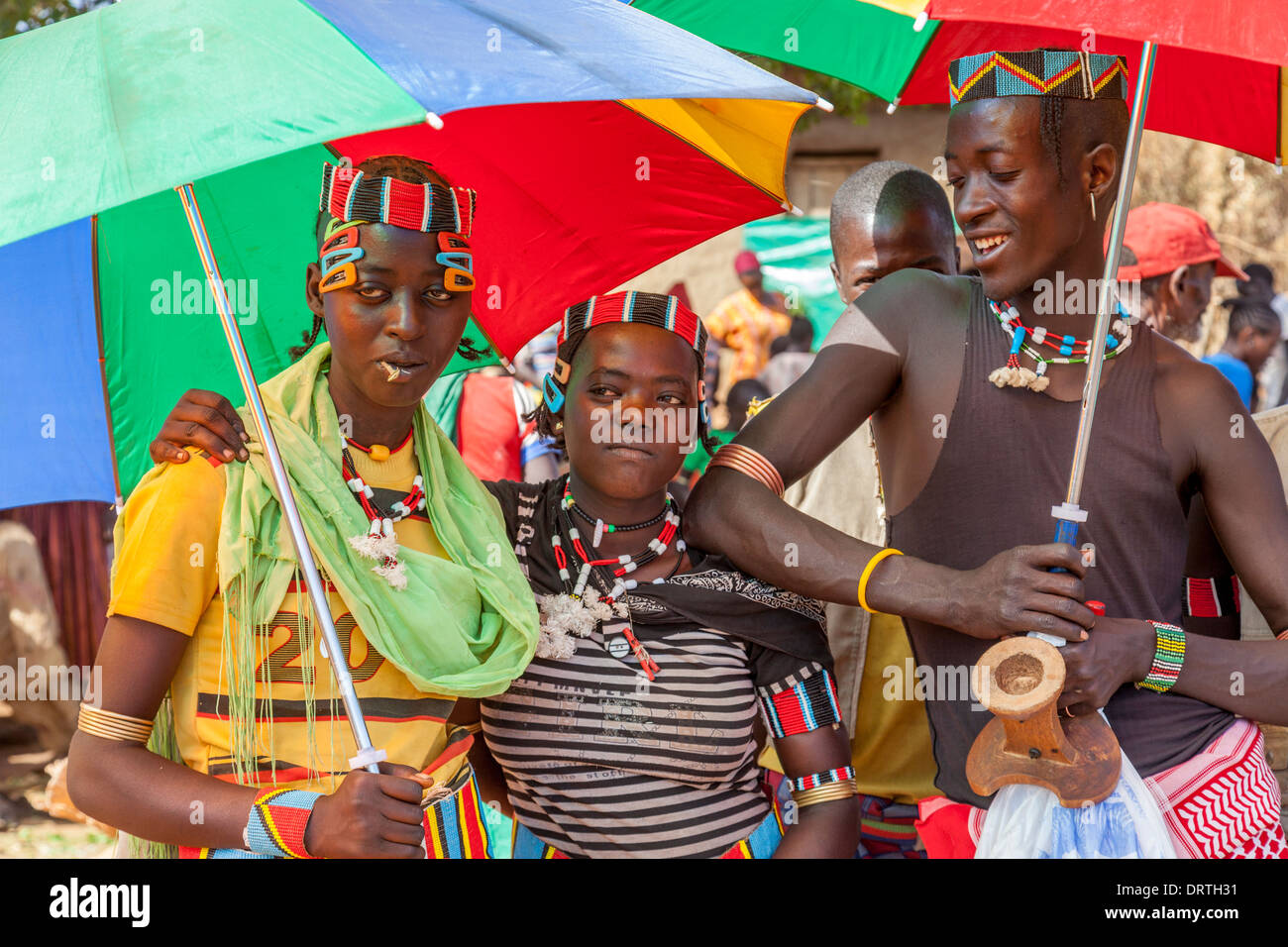 Young People From The Banna Tribe Stand Under Umbrellas At The Thursday ...