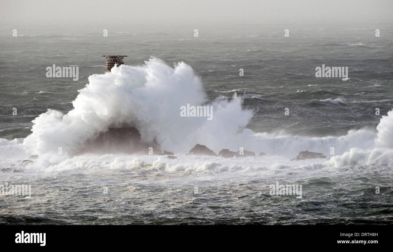 Long Ships Lighthouse at Lands Ends is engulfed by storm waves reaching ...