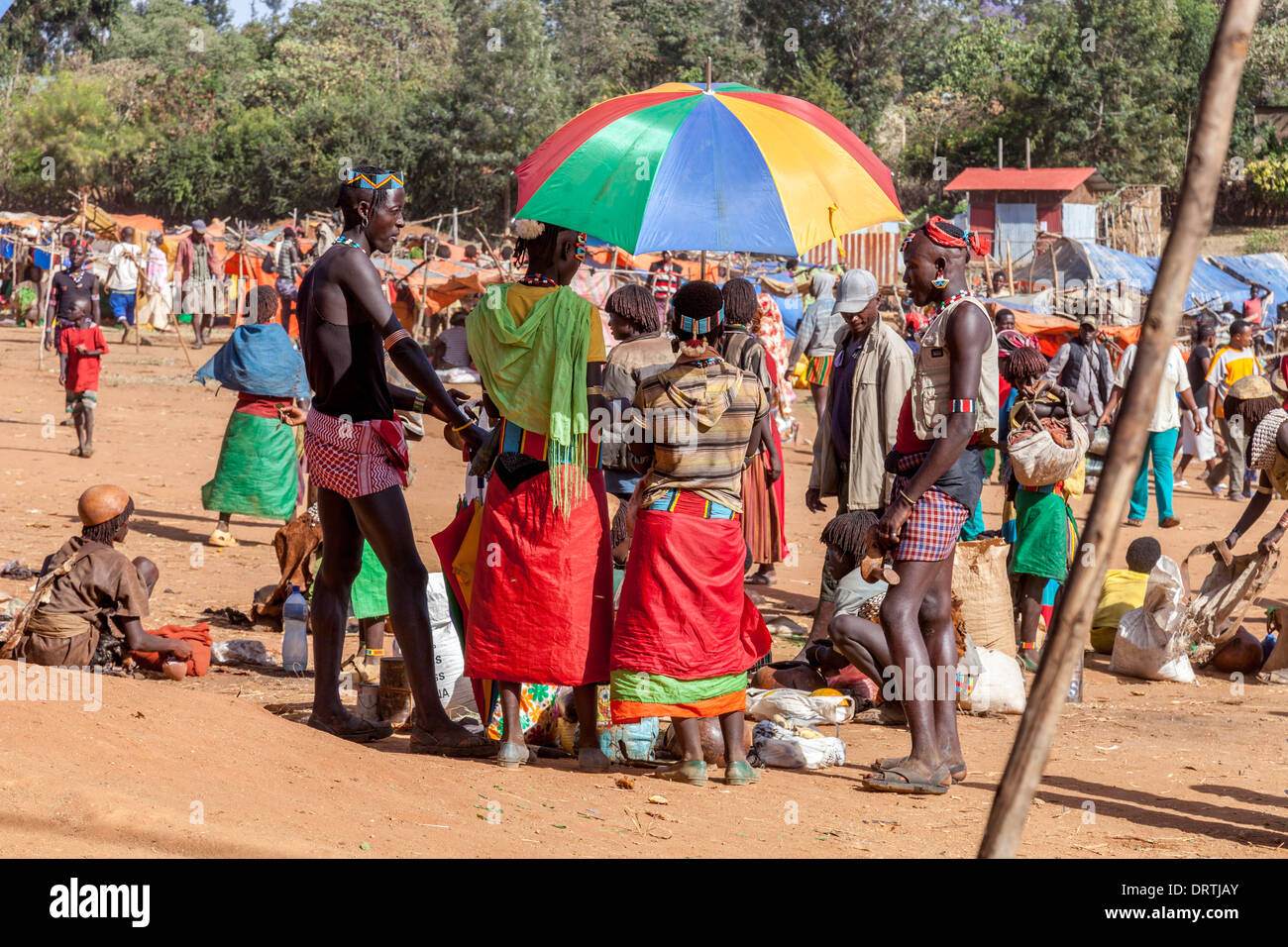 Young People From The Banna Tribe Stand Under Umbrellas At The Thursday ...