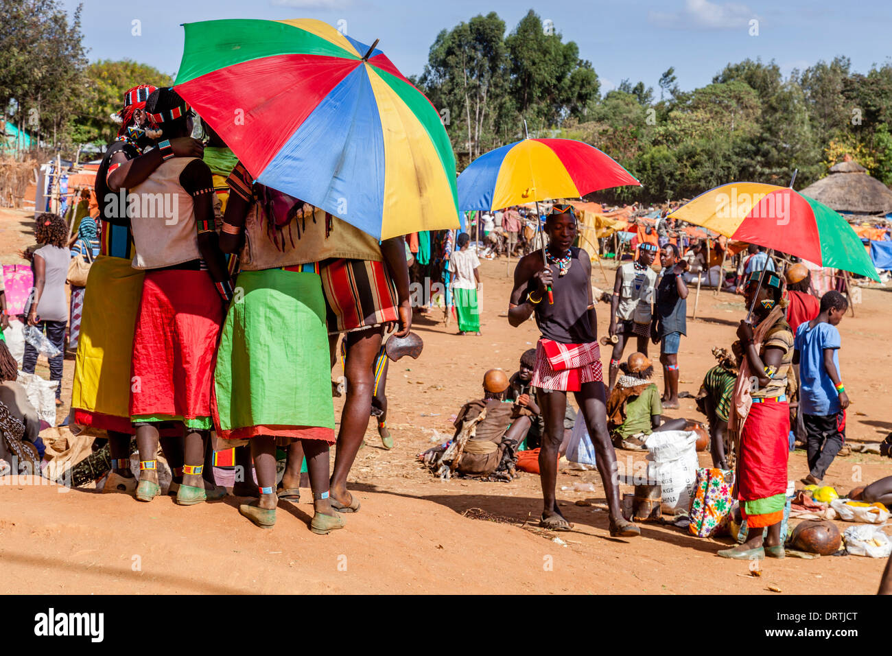 Young People From The Banna Tribe Stand Under Umbrellas At The Thursday ...