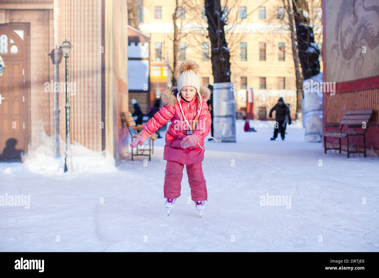 Adorable happy little girl enjoying skating at the ice-rink Stock Photo ...