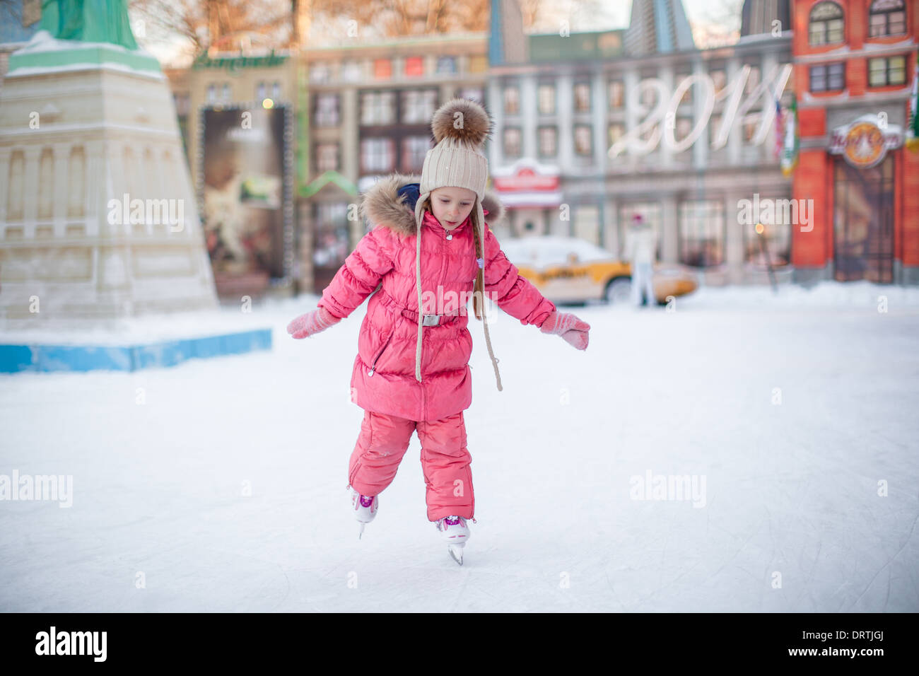 Adorable happy little girl enjoying skating at the ice-rink Stock Photo ...