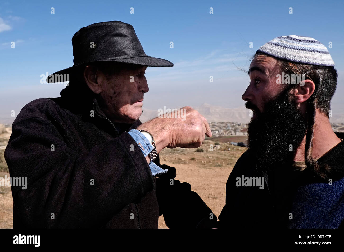 An Israeli left wing supporter and a young Jewish settler having a ...