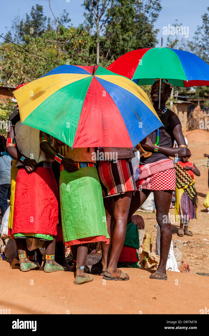 Young People From The Banna Tribe Stand Under Umbrellas At The Thursday ...