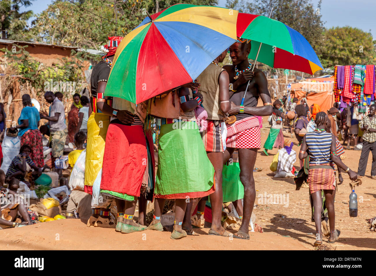 Young People From The Banna Tribe Stand Under Umbrellas At The Thursday ...