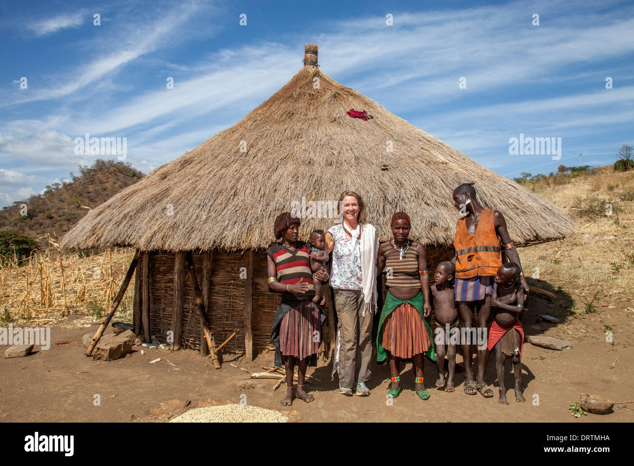 Banna Tribe Family And Tourist Pose Outside Their Home, Omo Valley ...